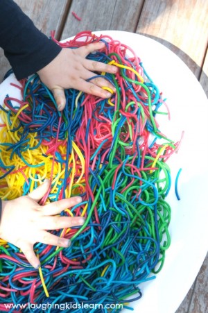 Playing with rainbow coloured spaghetti - Laughing Kids Learn